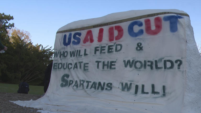 MSU researchers hold USAID funding cut rally at The Rock