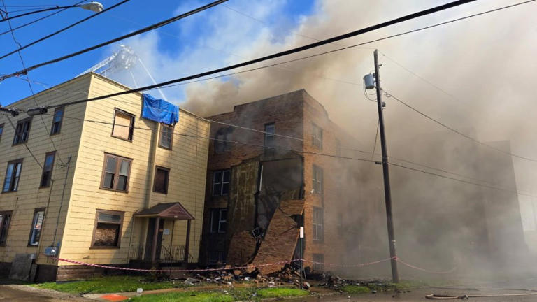 Man jumps from third story apartment in Canton as building goes up in flames