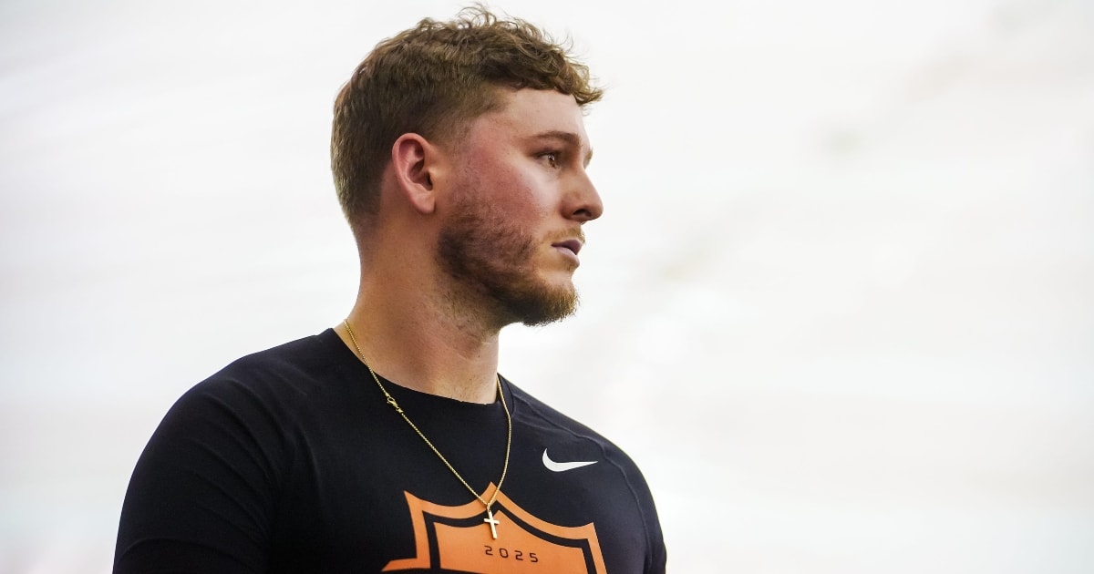 Quinn Ewers wipes tears away while taking Miami Dolphins draft phone call