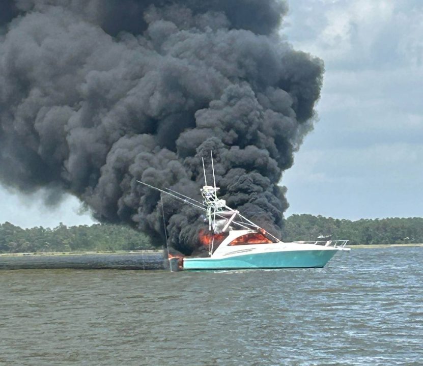 Three rescued after sport fishing boat catches fire