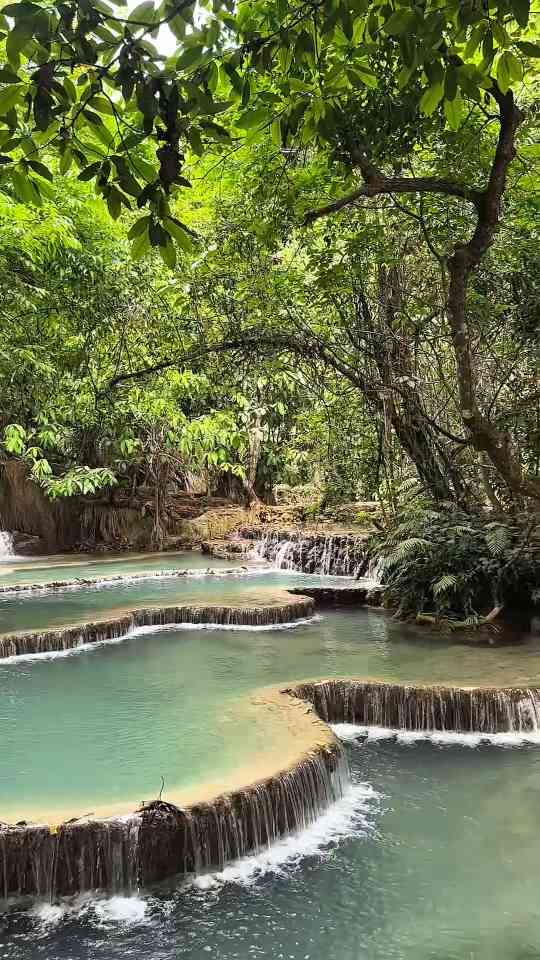 Serene Swim Beneath the Cascades at Kuang Si Waterfall in Laos