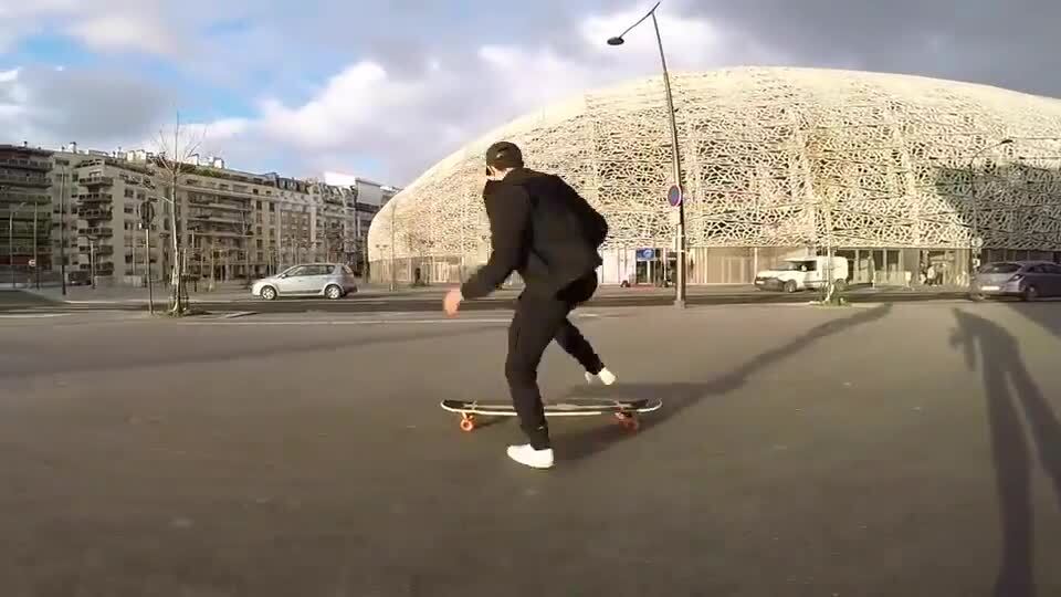Guy Spins on Tail End of Longboard