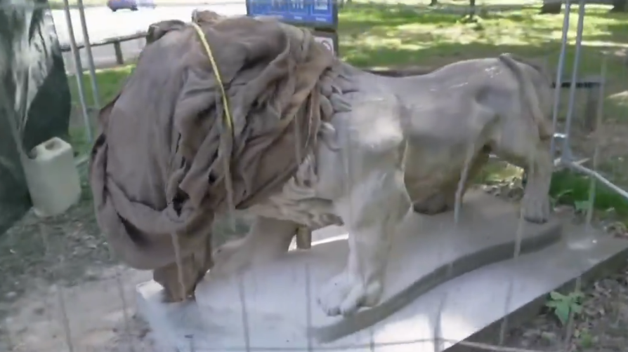 Reworked lion statue is 'so ugly' a bag has been put over its head