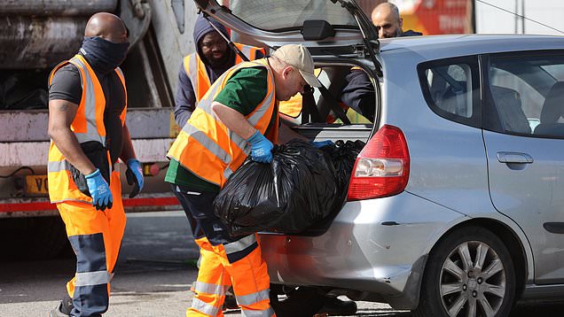 Cars full of litter line up in front of mobile bin lorries in Birmingham