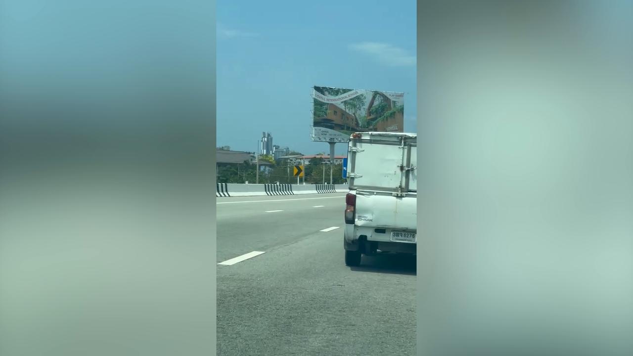 Stray wheel rolls on road alongside cars at motorway