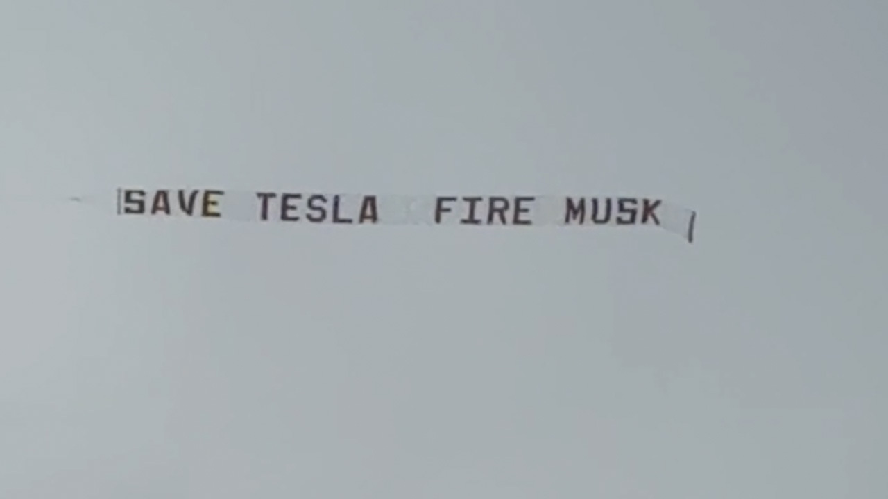 'Save Tesla Fire Musk' banner over downtown Austin