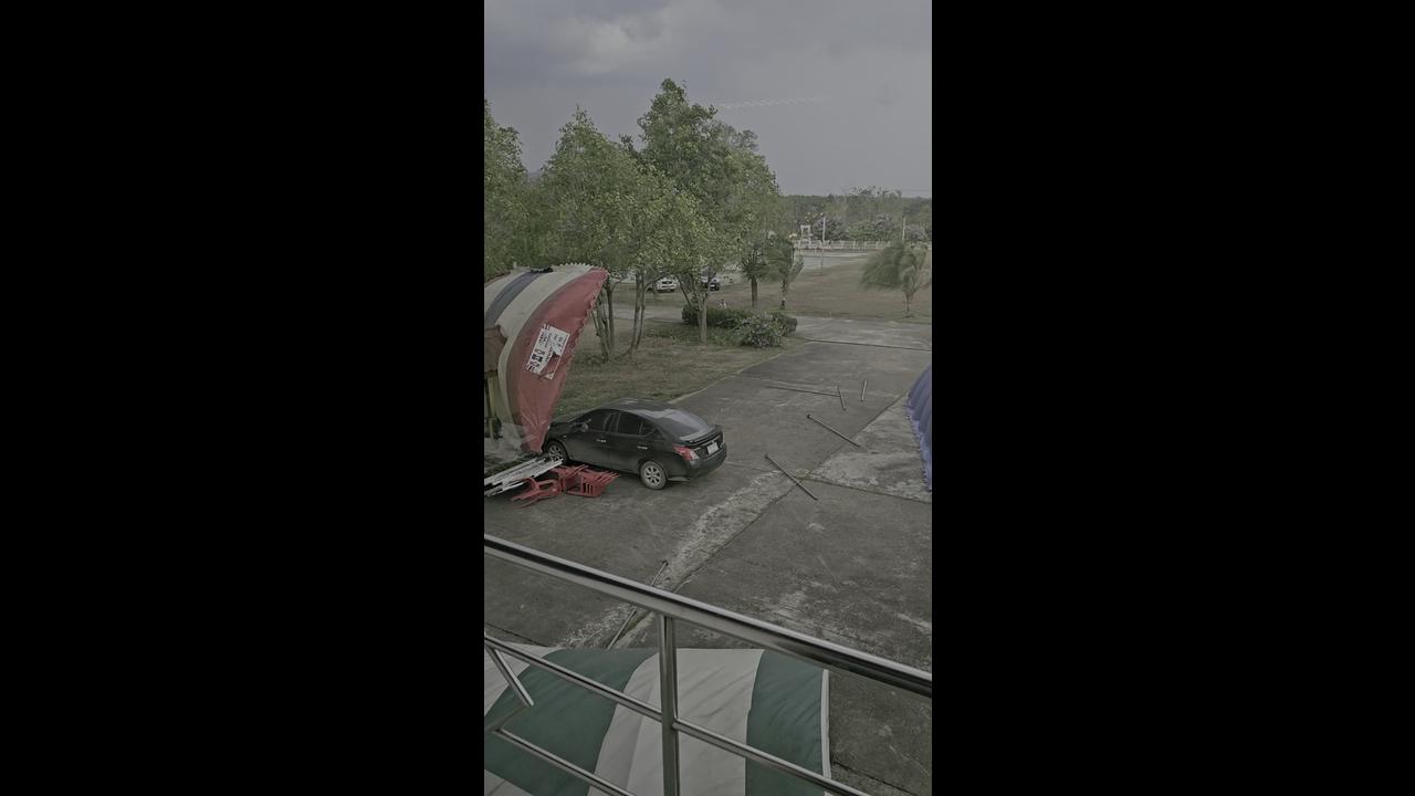 Tents uprooted by sudden wind crash into building