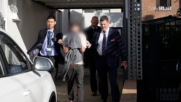 Heavily armed police storm the home of an alleged hacker