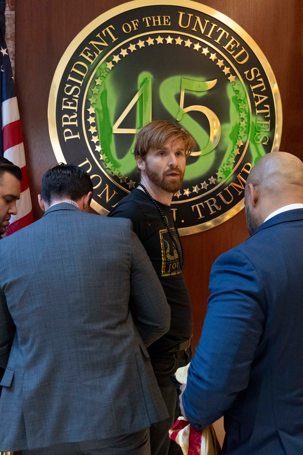 Climate protester arrested after spray painting over presidential ...