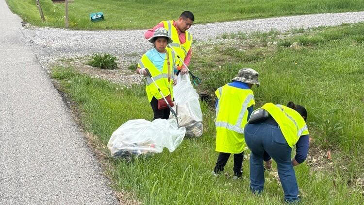 Students pick up trash to earn money for new playground equipment
