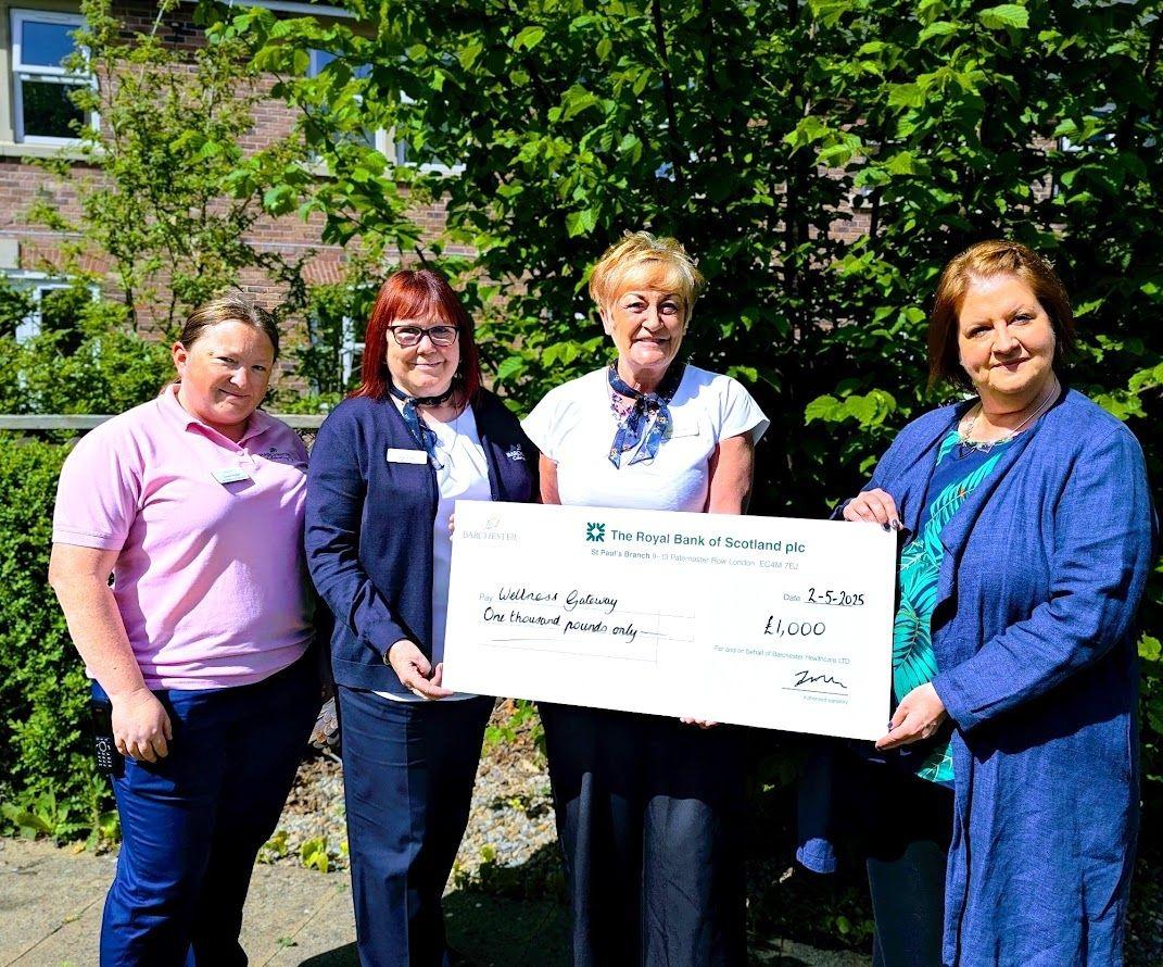 Care home presents cheque to local charity