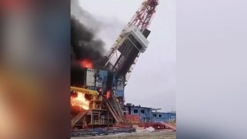 Russia: Burning oil rig collapses