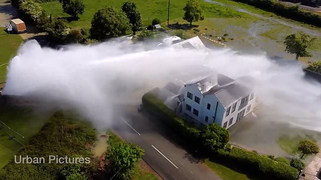 Burst water main sends thousands of gallons of water into the air ...