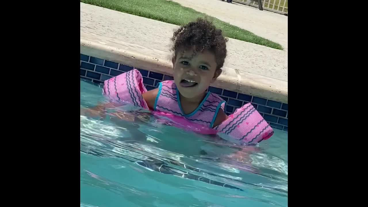Cute Toddler's Exciting Pool Day: Learning to Swim with Floaties