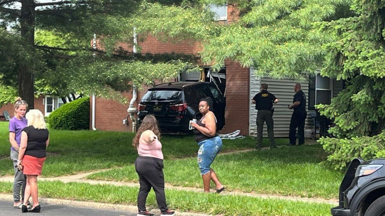 Person rushed to hospital after vehicle slams into building