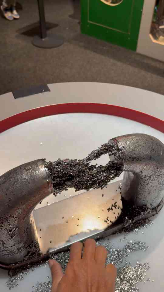 Building a Magnetic Bridge with Metal Filings in a Science Exhibit