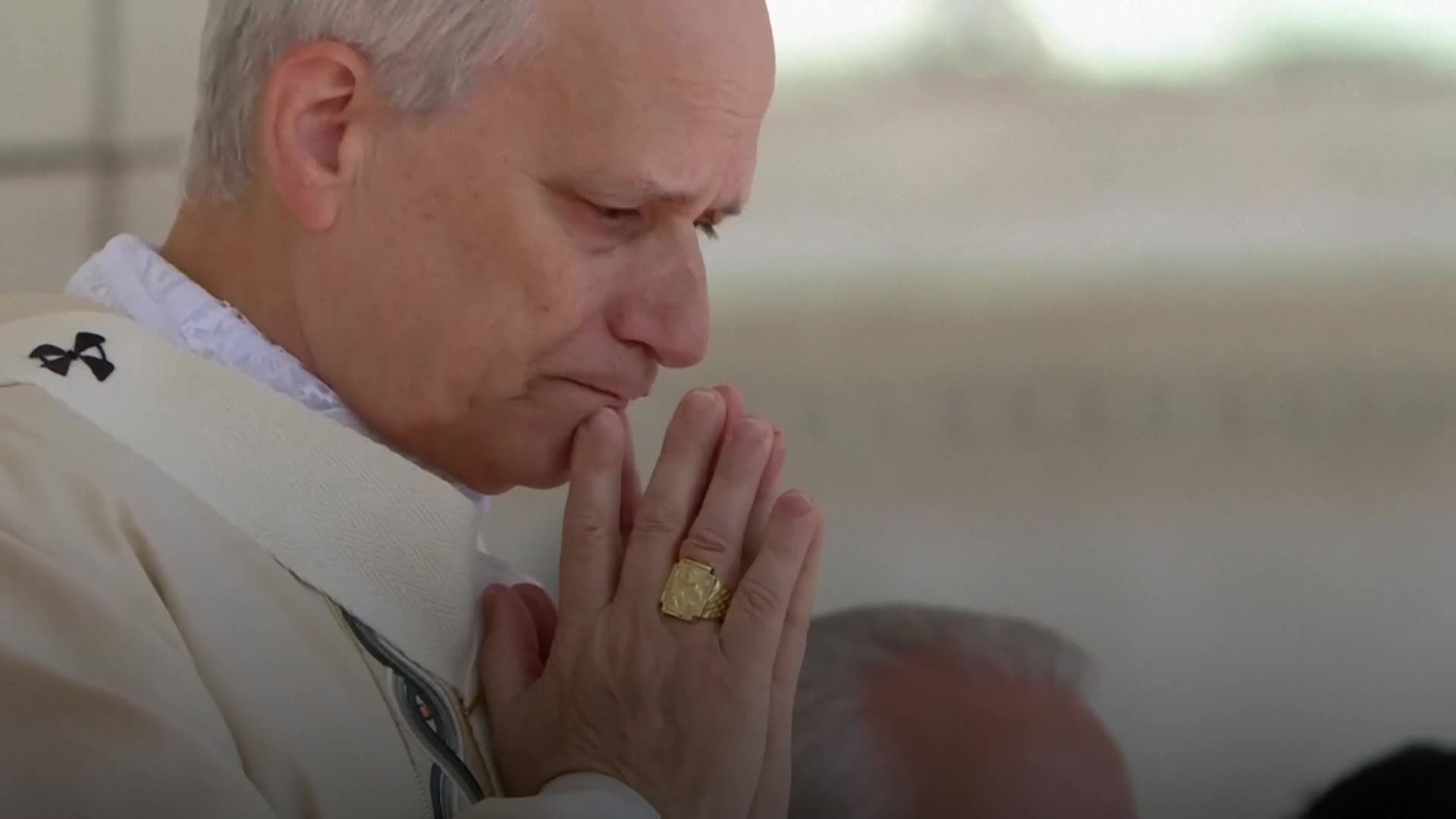 Pope Leo XVI appears to choke up as he is invested with papal symbols ...