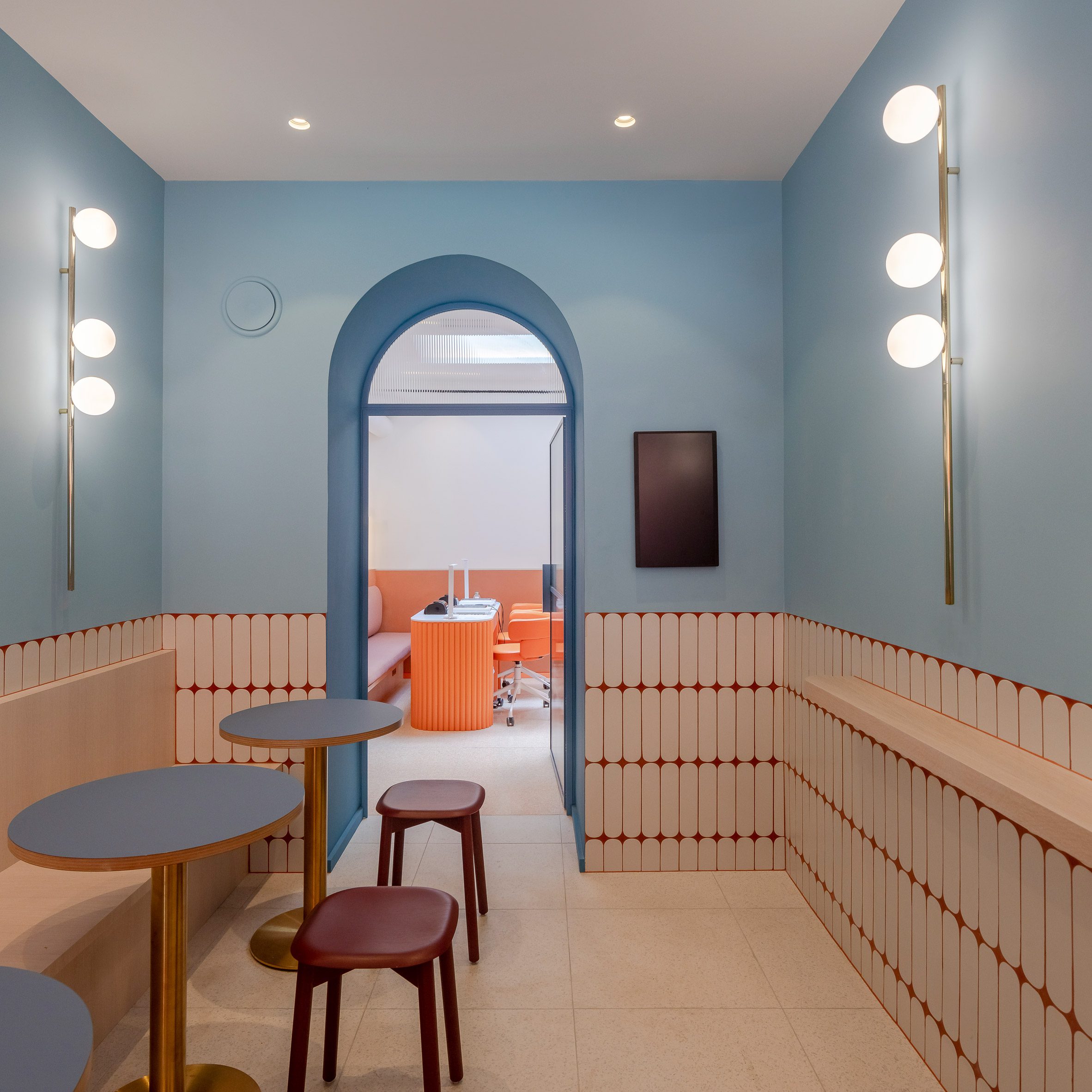 Tigg Coll pairs orange with blue in Cona coffee bar and nail salon