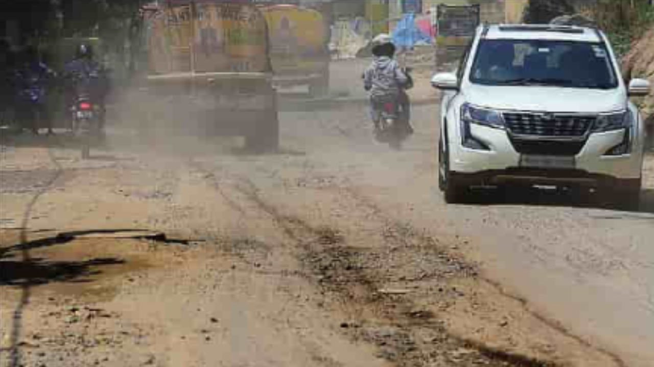 Dusty and broken Holiday Village Road in Bengaluru poses health hazards