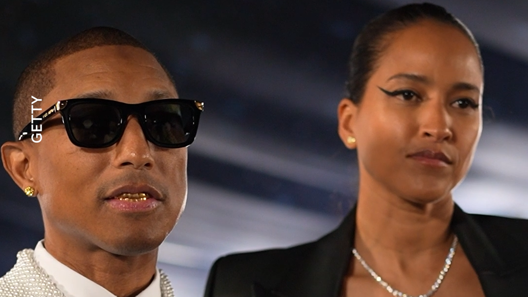 Pharrell Williams arrives to the Met Gala red carpet looking dapper