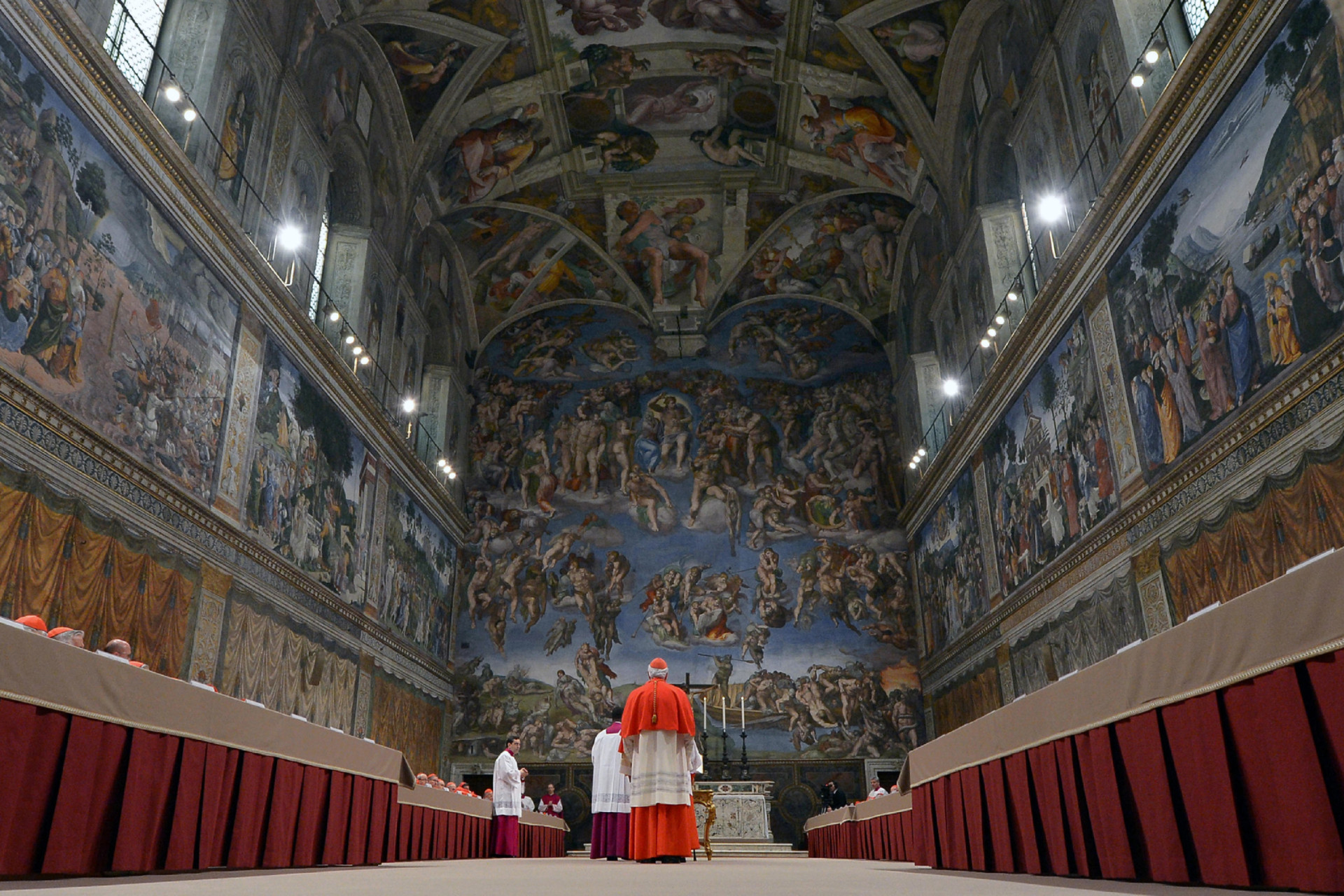 What is painted on the ceiling of the Sistine Chapel?