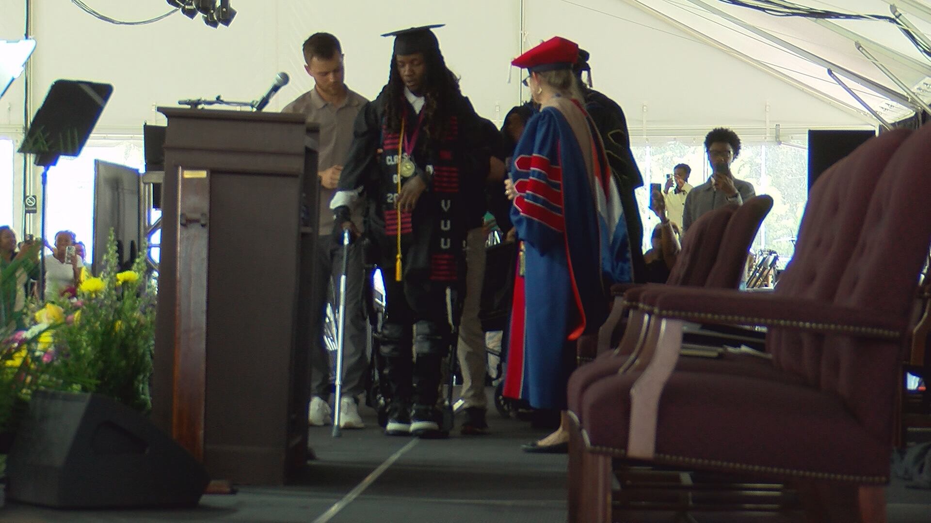 Wearable robot helps VUU graduate walk across stage after spinal cord ...