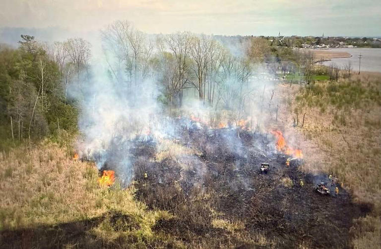 Multiple agencies work to put out 25-30 acre brush fire in Two Rivers