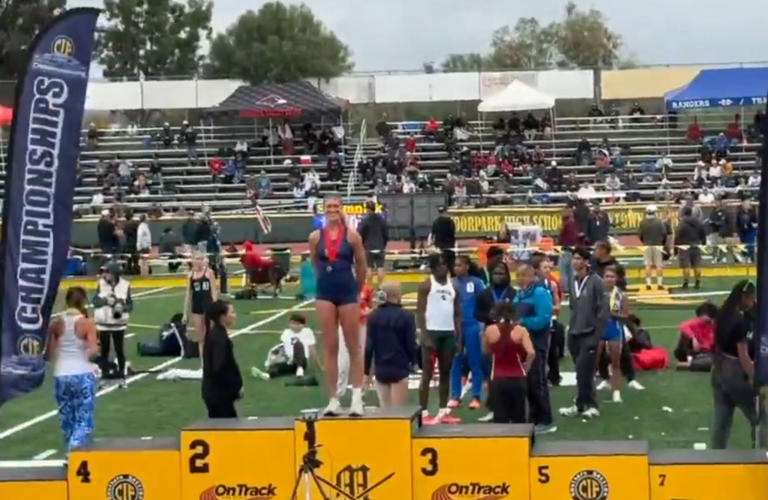 High school female track star poses on first-place podium after ...