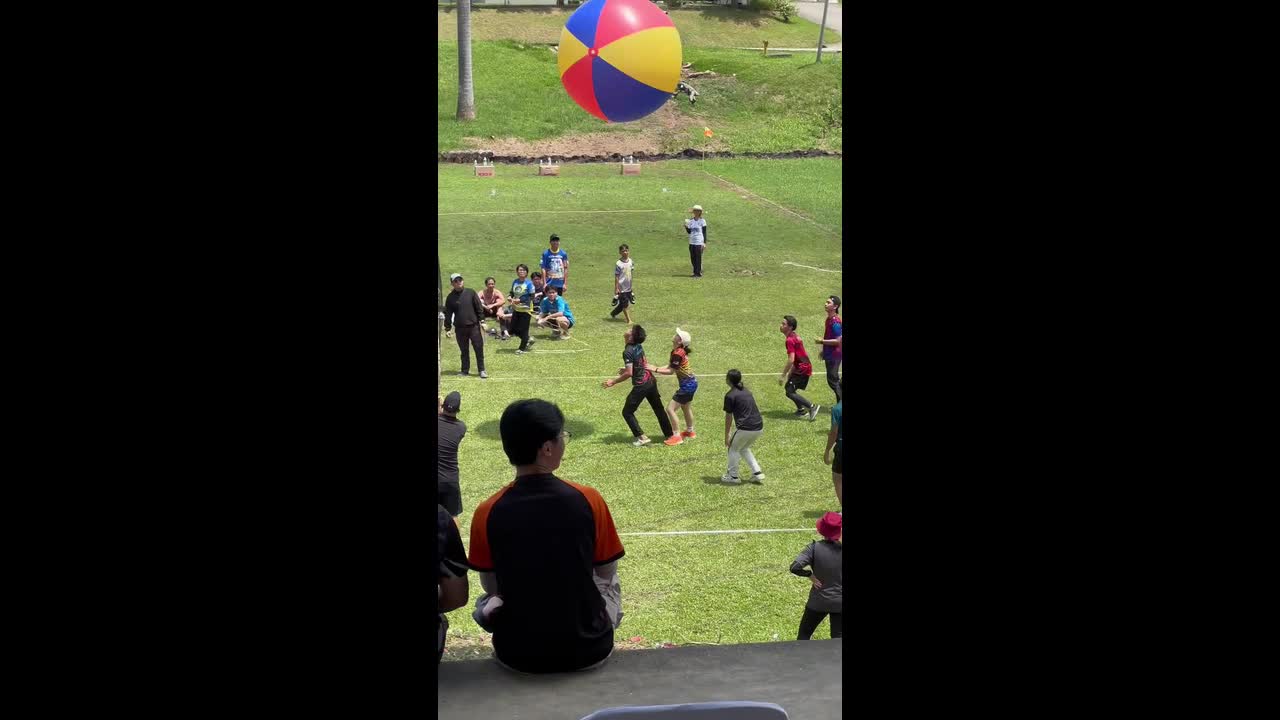 Pupils have fun on sports day playing with giant volleyball