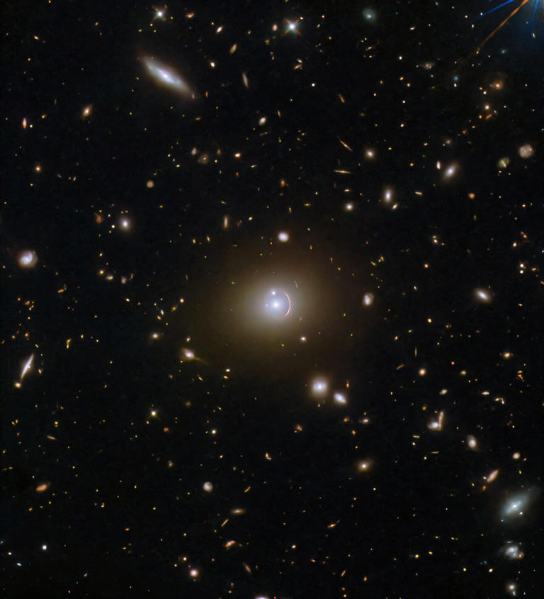 Hubble captures distant galaxy's light bent into a partial Einstein ring