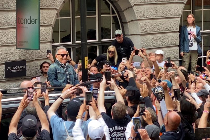 Bruce Springsteen springs onto car to greet huge crowd of fans outside ...