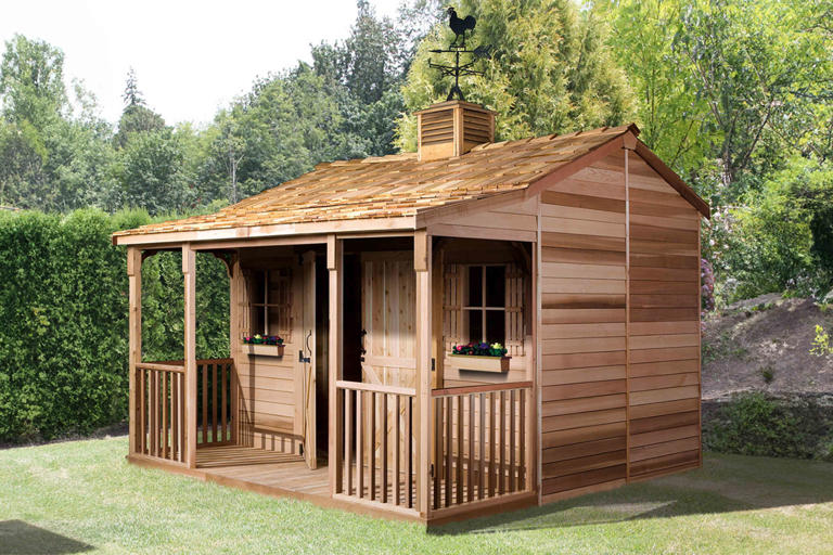 This charming cabin-style tiny house has a full front porch, flower ...