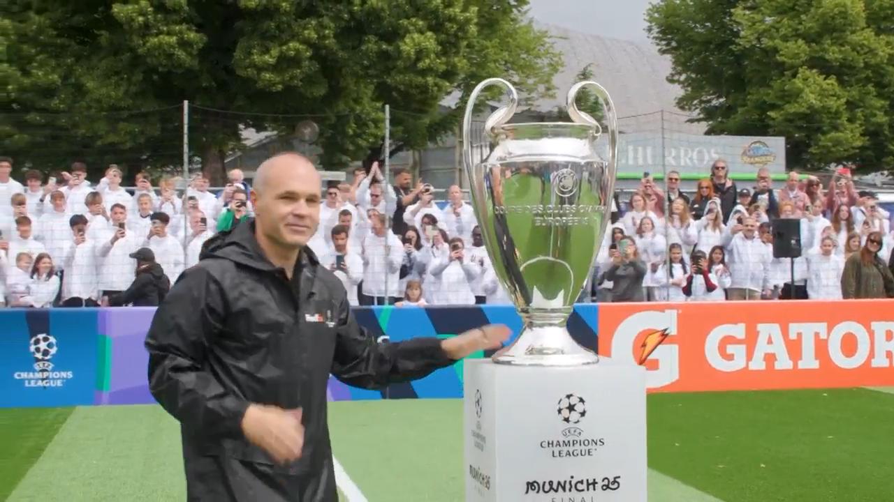 Andres Iniesta delivers Champions League trophy to Munich