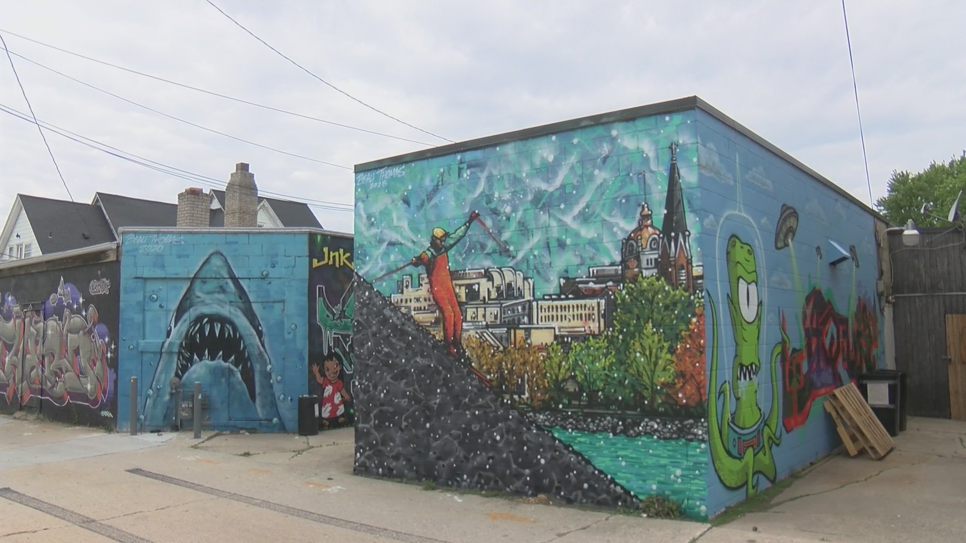 Local mural painter finishes new artwork, showcasing person skiing down ...