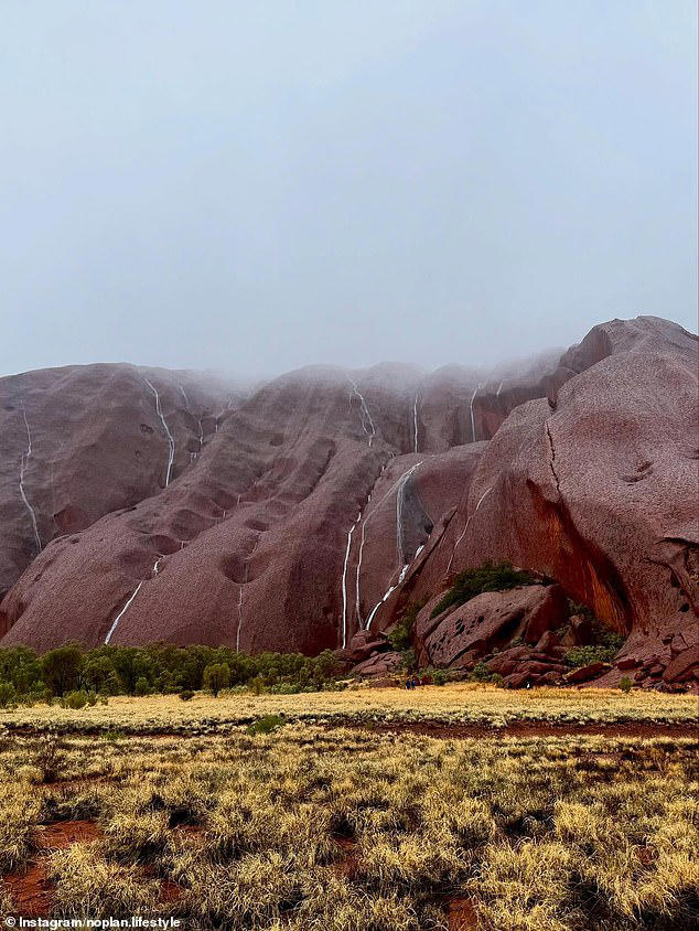 Stunning photos capture the rare moment water cascades down Uluru