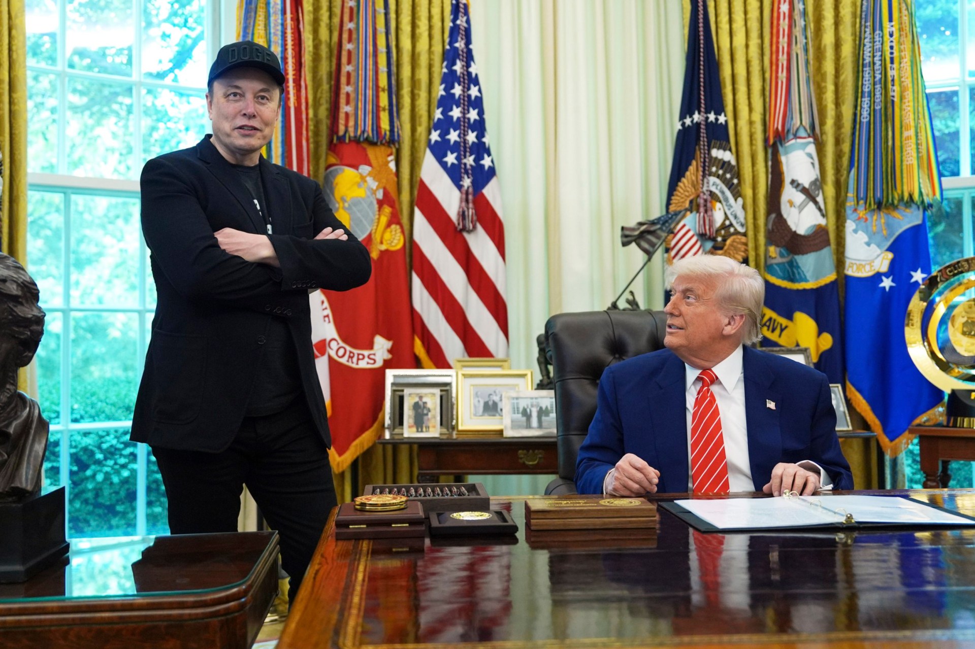 Elon Musk wears 'The Dogefather' shirt and accepts golden key from Trump