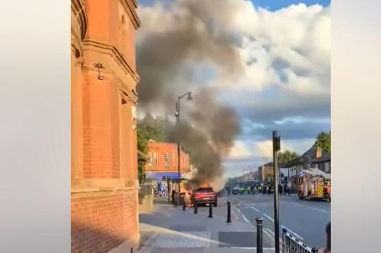 Car bursts into flames on busy main road