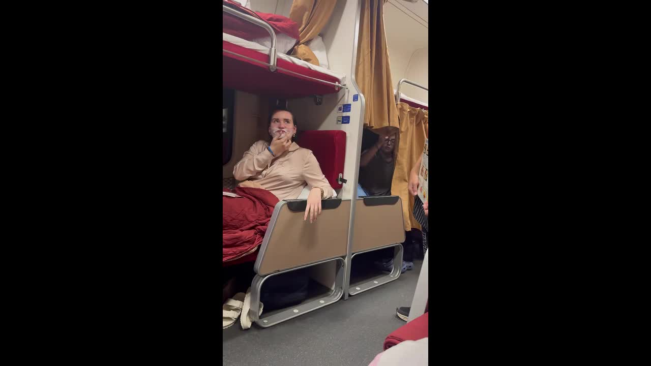 Server laughs at face masks during sleeper train ride in Bangkok, Thailand