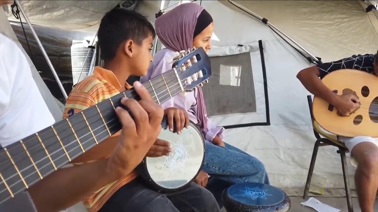 Gaza music teacher tries to turn despair into hope, teaching music to ...
