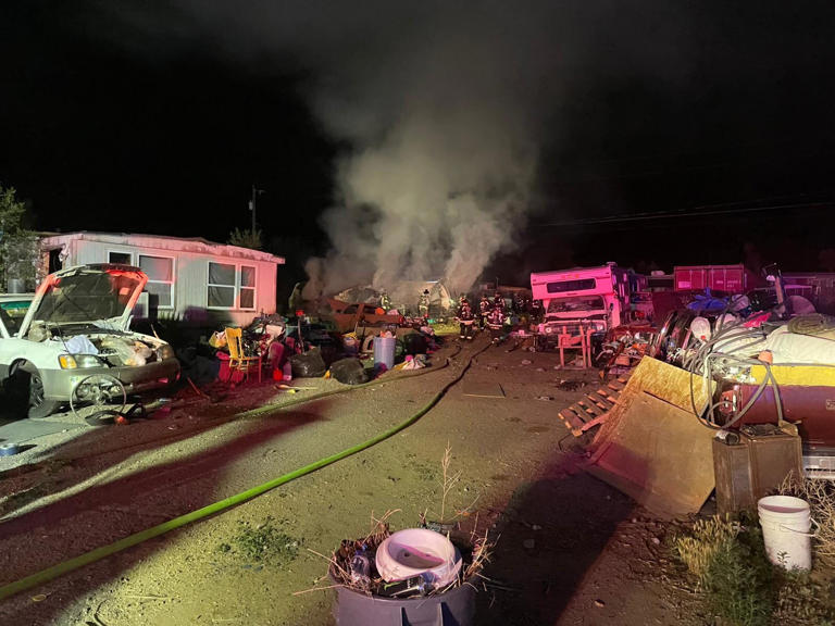 Trailer, disabled vehicles, debris charred in overnight fire