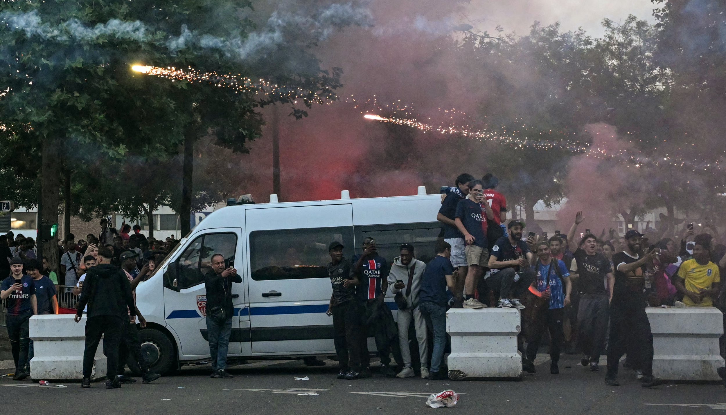 Masked fans hurl fireworks at riot police in Champions League final clash