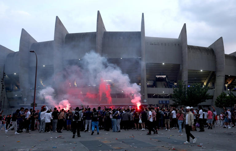 Masked fans hurl fireworks at riot police in Champions League final clash