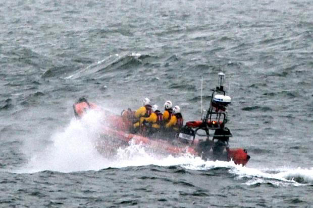 Coastguard and volunteer lifeboat crew rescue paddleboarder blown out ...