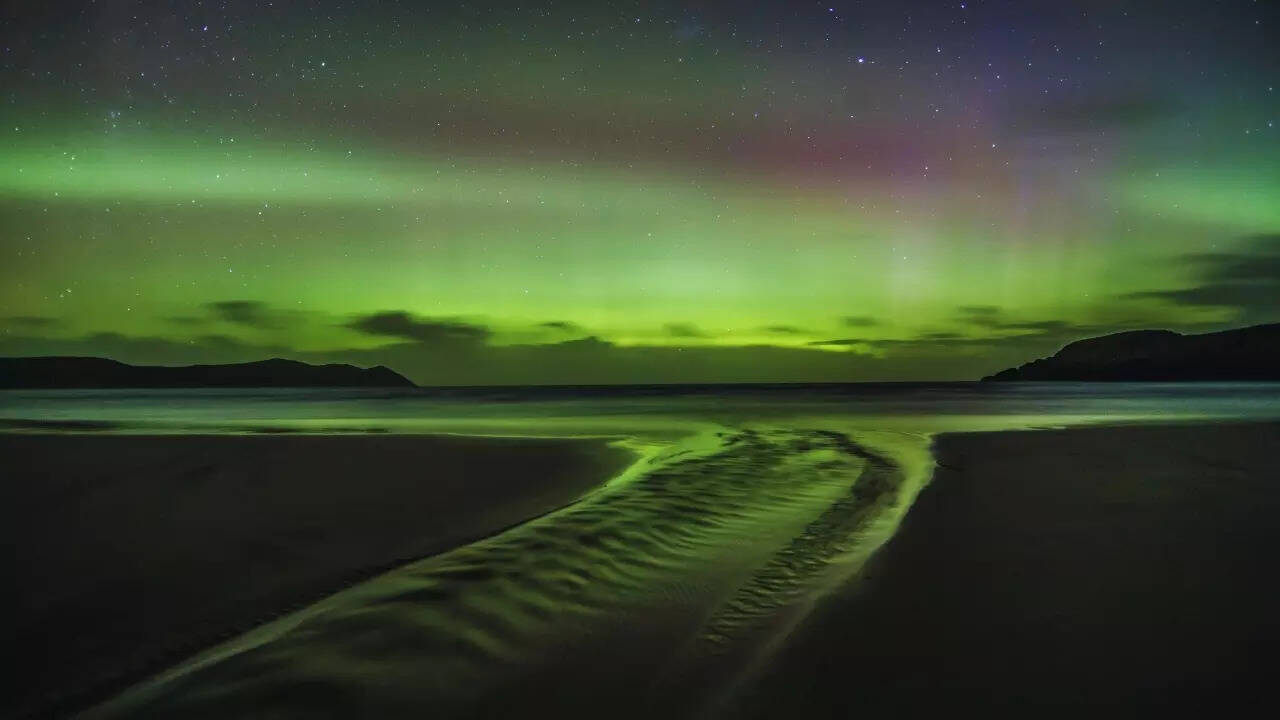 Sydney night sky struck by Green meteor amidst Southern Lights