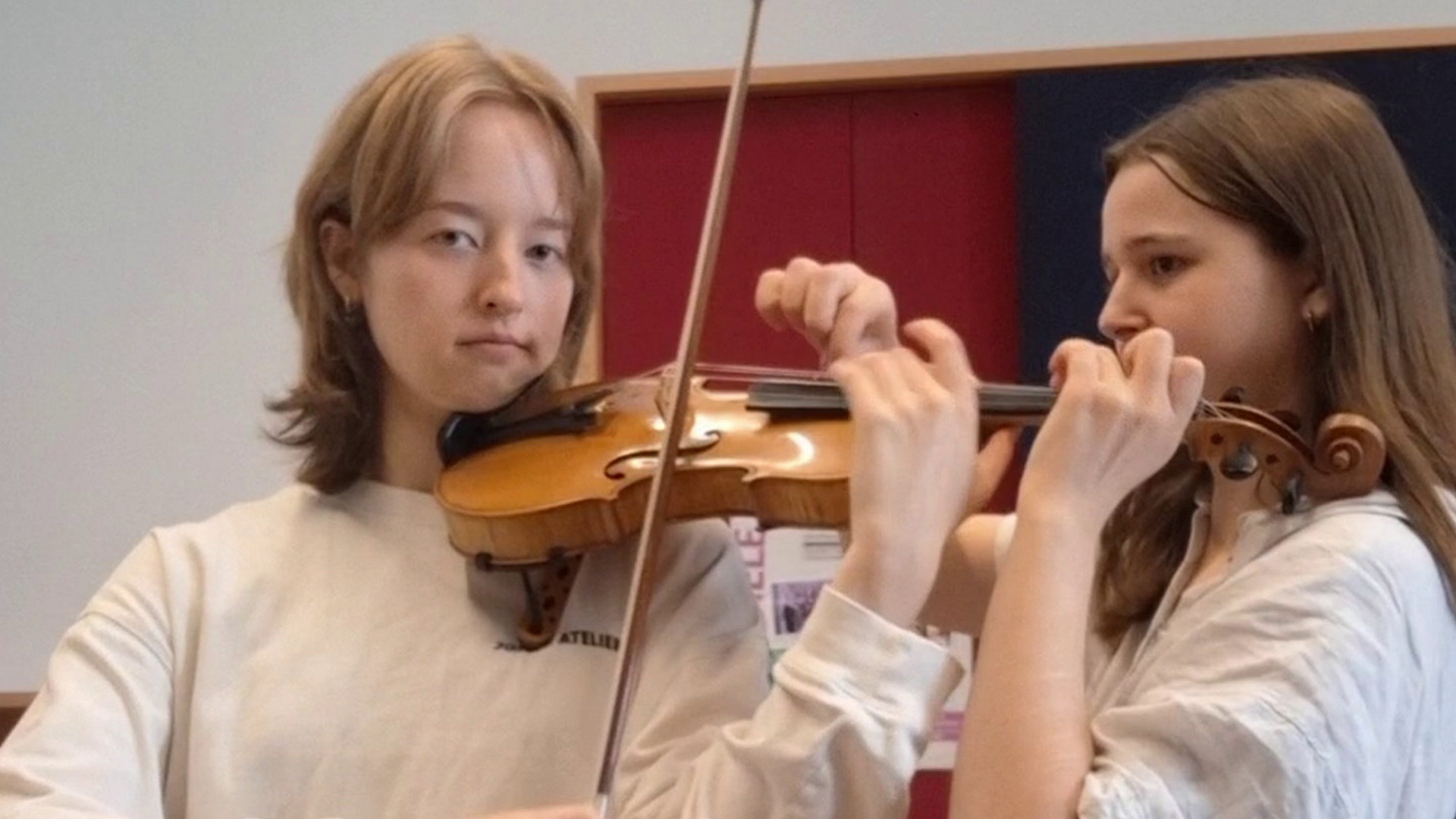Violin students learn to play a single violin at the same time