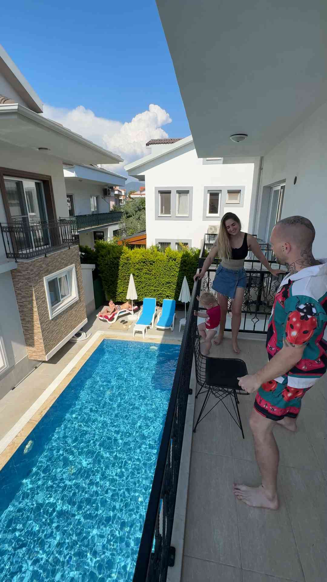 Man Performing a Bold Balcony Jump into a Swimming Pool