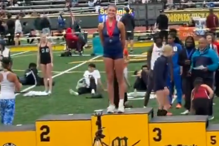 Track athlete poses on 1st place at podium after losing to trans rival