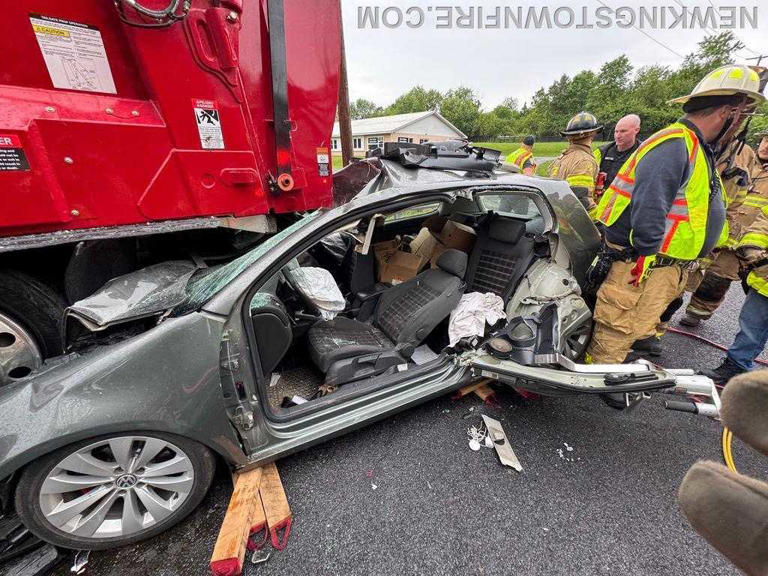Car crushed after ramming into garbage truck, trapping person inside