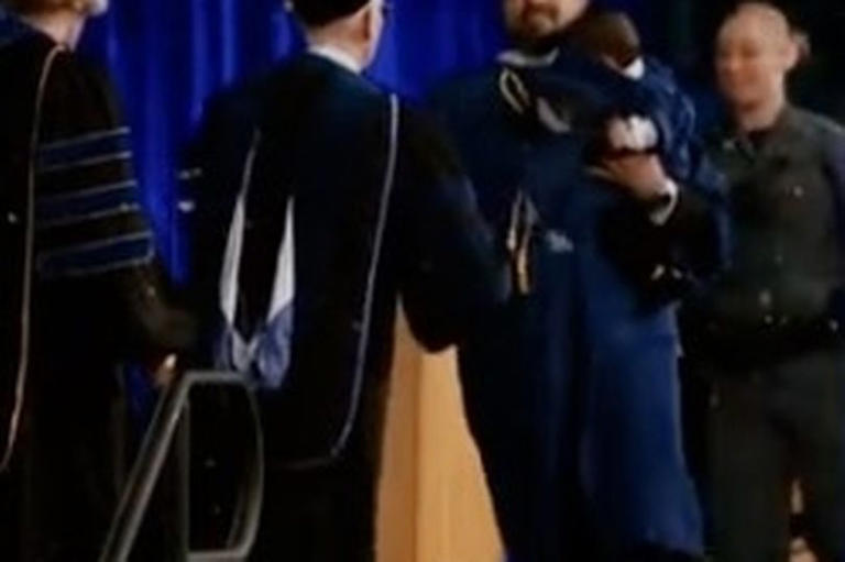 Father Sprints Across Stage At Graduation With Baby In Arms As Security