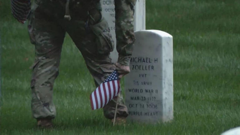 WATCH: Soldiers place flags on the graves of fallen service members